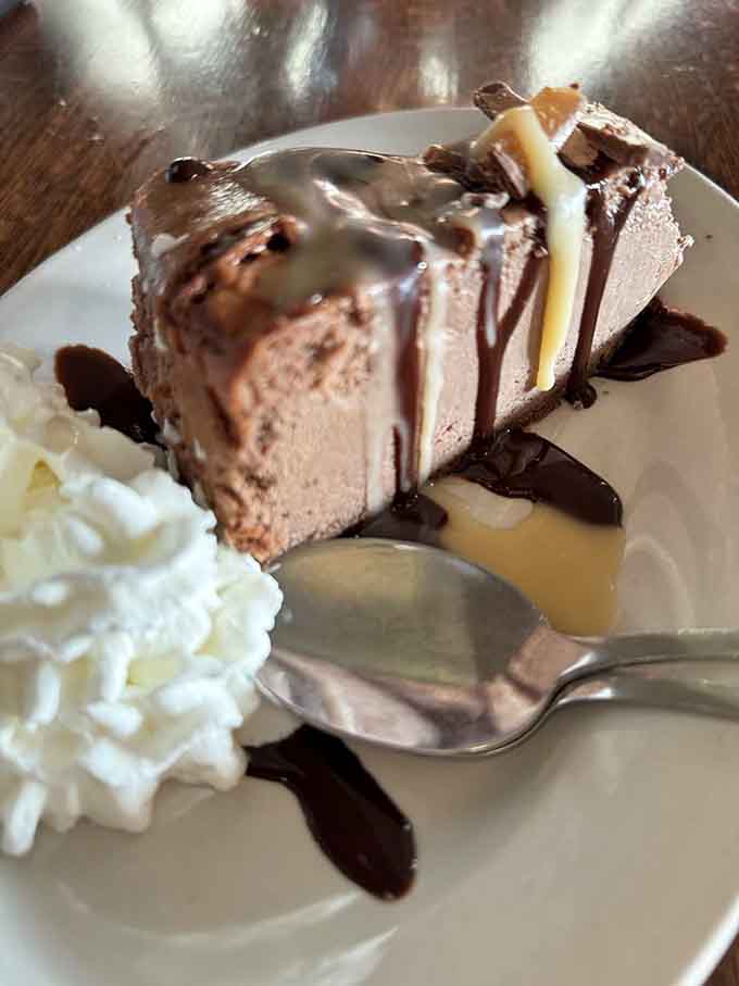 Cheesecake drizzled with chocolate sauce that provides the perfect sweet ending to your savory British pub feast adventure.