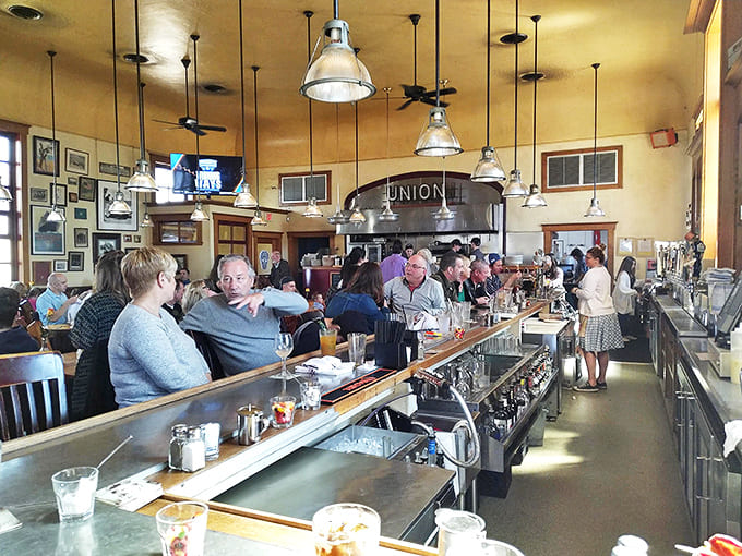 The counter seating offers front-row views of the bartenders' craft while fostering the community spirit that defines Clarkston Union.