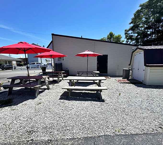 Red umbrellas provide shade for outdoor diners enjoying their sliders in the fresh Ohio air.