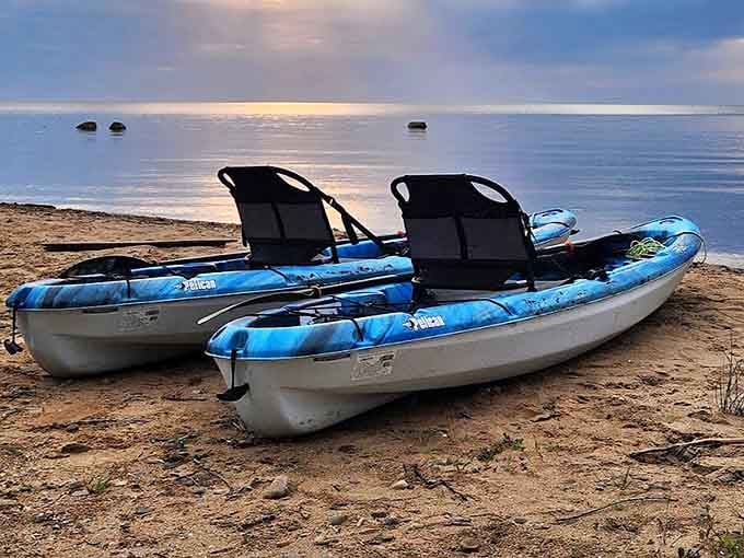 Morning calm settles over Delaware Park's shores, where kayaks wait patiently for adventures on Lake Huron's inviting waters.