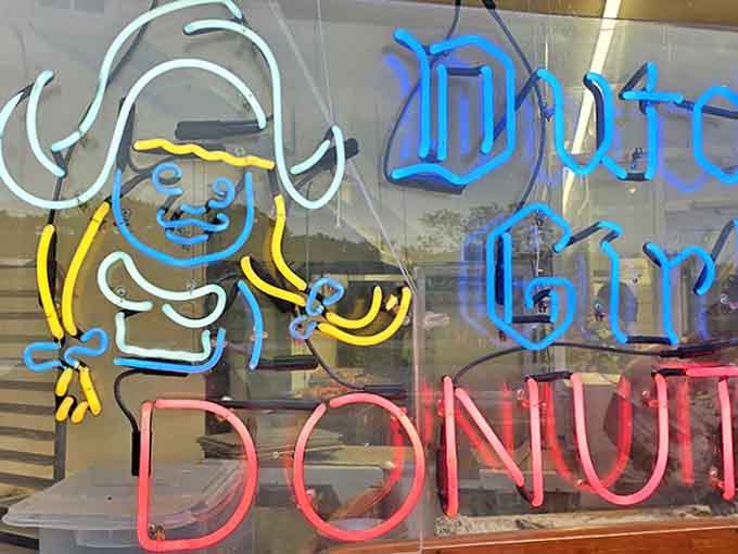 The neon Dutch Girl sign glows with nostalgic charm, a beacon of sweetness that's been guiding Detroiters to donut bliss for generations.