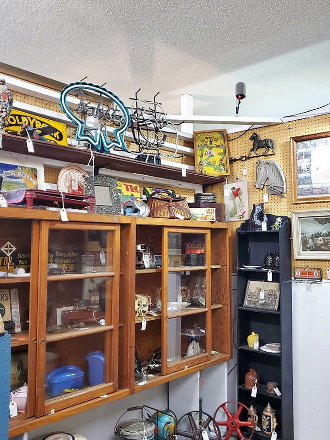 Vintage cabinets house an eclectic mix of collectibles, from antique signage to decorative items spanning multiple decades.