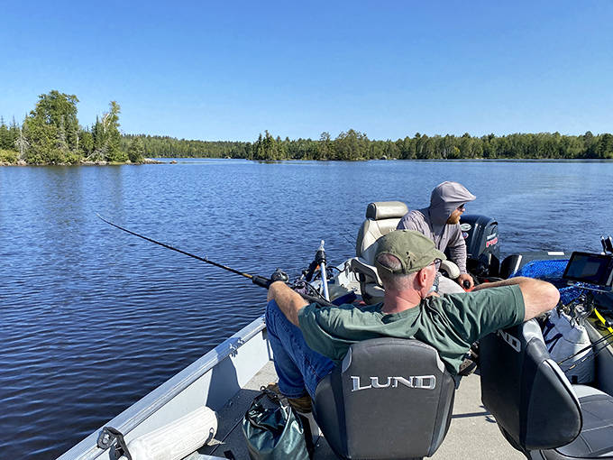 The serious business of fishing brings these anglers to Ely's pristine waters, where walleye and northern pike await beneath the glassy surface.