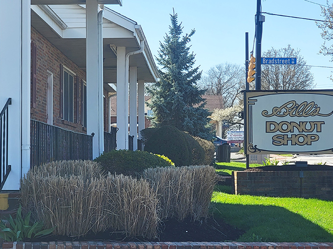 Exterior: Morning sunshine bathes Bill's brick fa&ccedil;ade, as the iconic sign beckons carb enthusiasts from near and far.