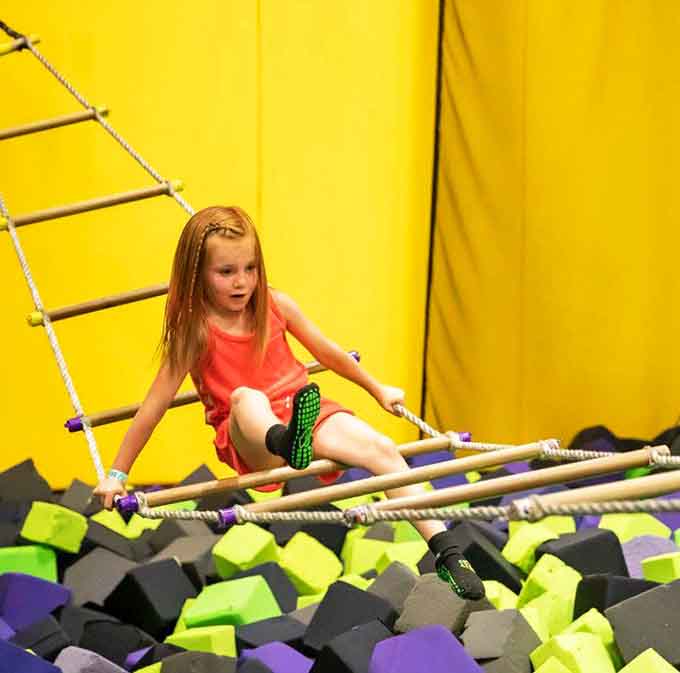 The fidget ladder challenges balance, strength, and your ability to maintain dignity while dangling above foam blocks. Spoiler: the blocks always win.