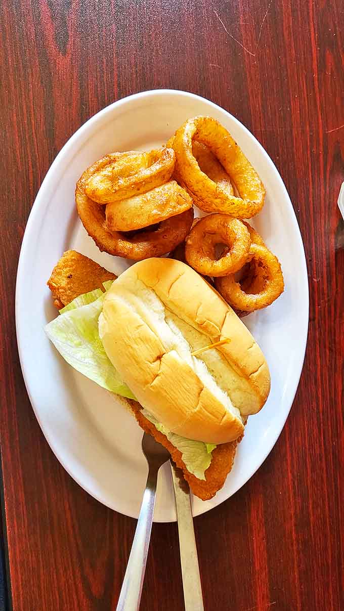 A classic fish sandwich with onion rings – because sometimes you need a proper meal before diving face-first into dessert heaven.