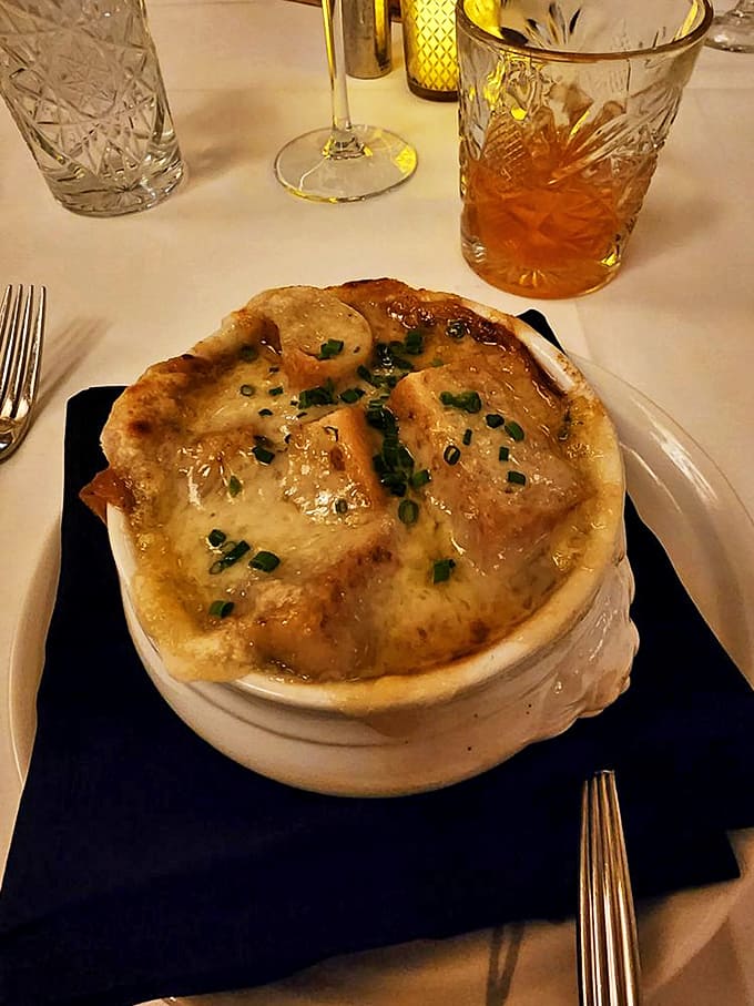 This isn't just French onion soup &ndash; it's a cheese-capped cauldron of savory comfort that makes you wonder why anyone bothers with other appetizers.