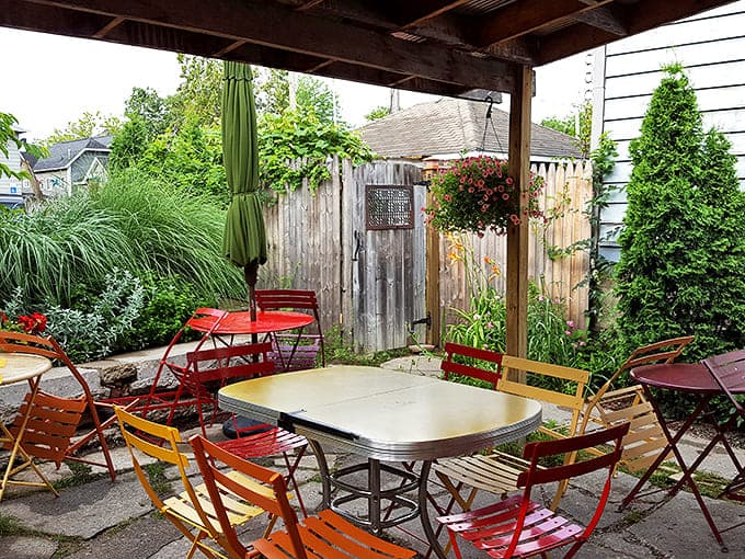 The secret garden patio out back, where mismatched chairs and colorful tables create the perfect setting for savoring every last bite.