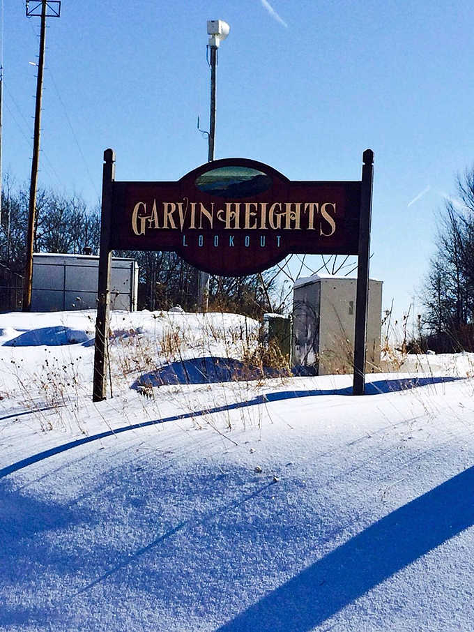 Even in winter, Garvin Heights beckons with its snow-dusted sign promising views worth the chilly journey.
