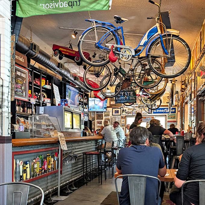The restaurant's interior combines industrial elements with warm lighting and wall-to-wall memorabilia, creating an immersive dining experience.