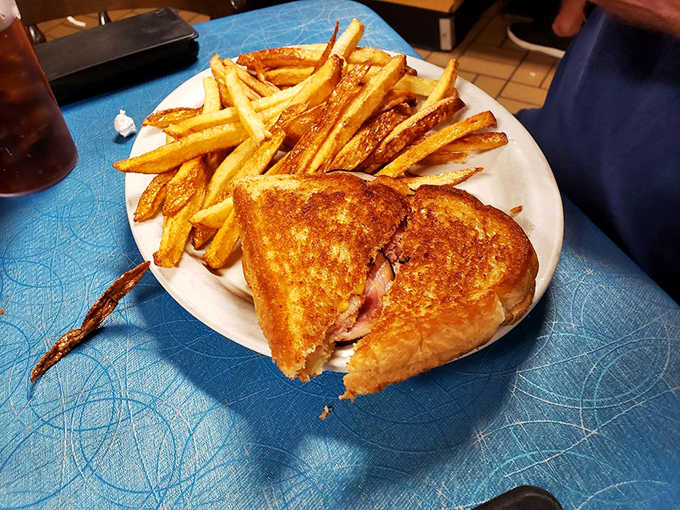 Grilled cheese elevated to art form &ndash; golden, buttery exterior giving way to perfectly melted cheese, served with hand-cut fries.