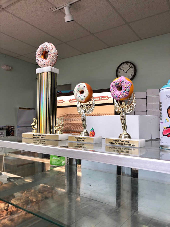 Trophy donuts perched atop awards tell you everything you need to know: this isn't just local bragging, it's officially recognized excellence in fried dough form.