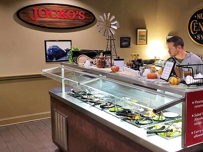 The salad bar stands ready like the responsible friend who reminds you to eat something green before demolishing that third slice of pepperoni.