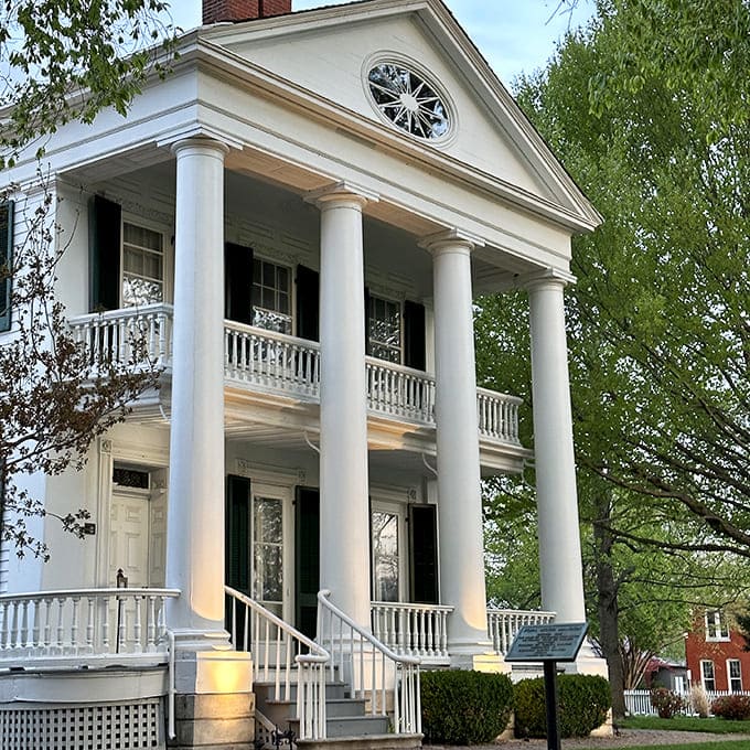 The John Wood Mansion stands as a perfect example of Greek Revival elegance, its columns reaching skyward like a Southern belle who found herself in Illinois.