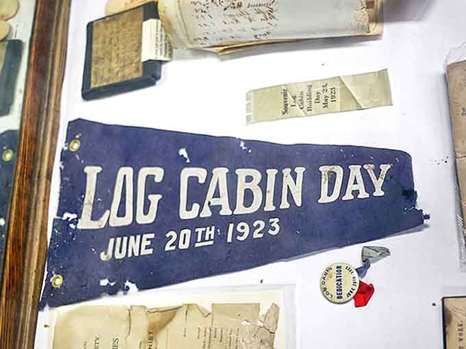 This faded pennant celebrates "Log Cabin Day" from 1923, when preserving pioneer history was already becoming a cherished tradition.