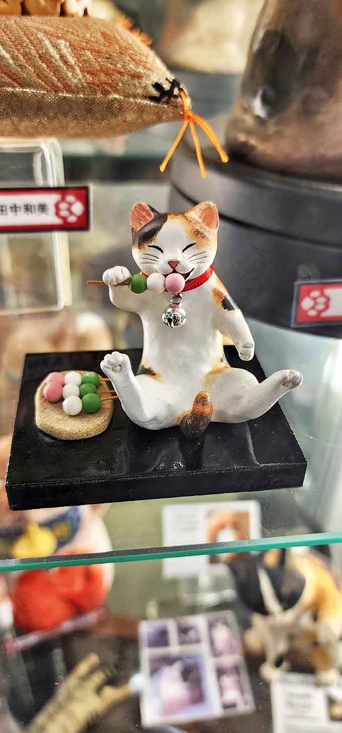 This delightful figurine enjoying dango sweets demonstrates the artistic detail found in many of the museum's special pieces.