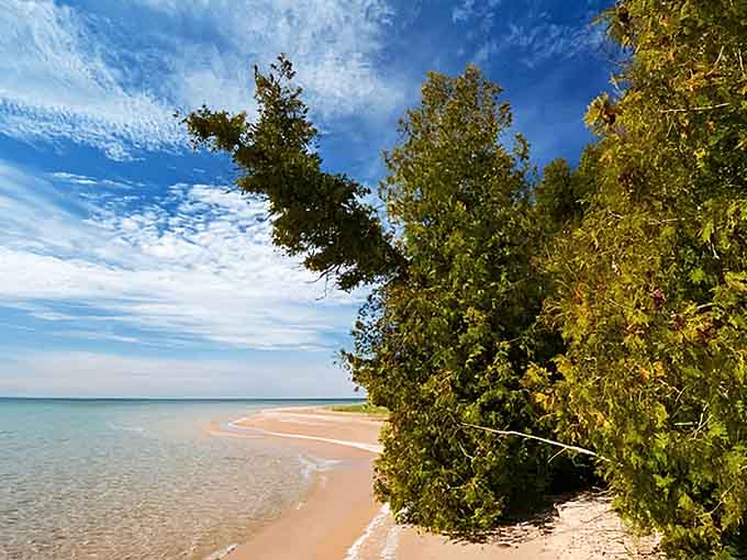 The Manitou Islands shimmer on the horizon like emeralds dropped in Lake Michigan's blue expanse, tempting adventurous day-trippers.