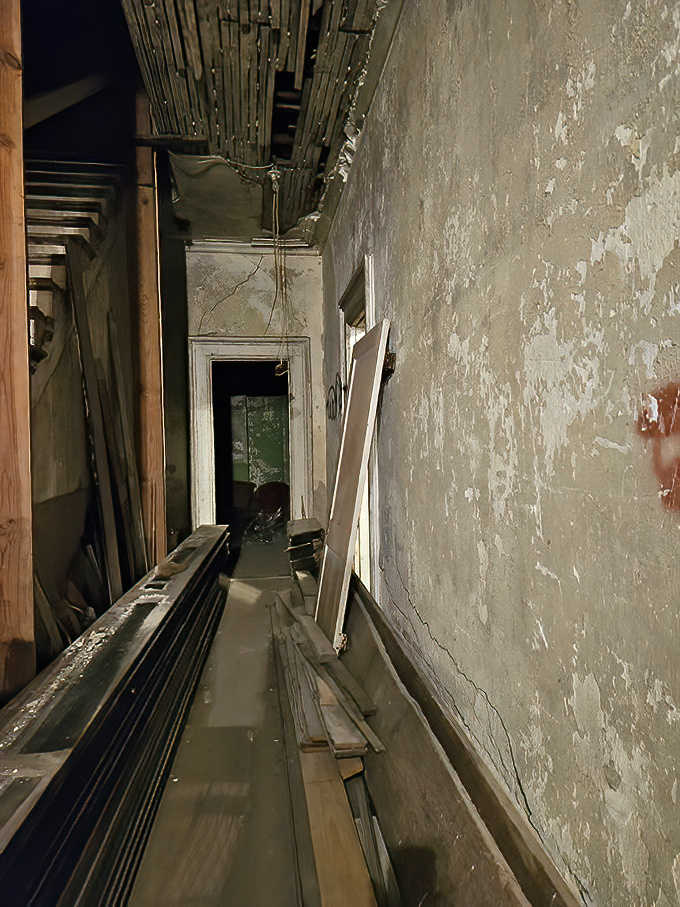 Peeling paint and exposed framework reveal the mansion's bones &ndash; a renovation challenge made more interesting when tools mysteriously relocate overnight.