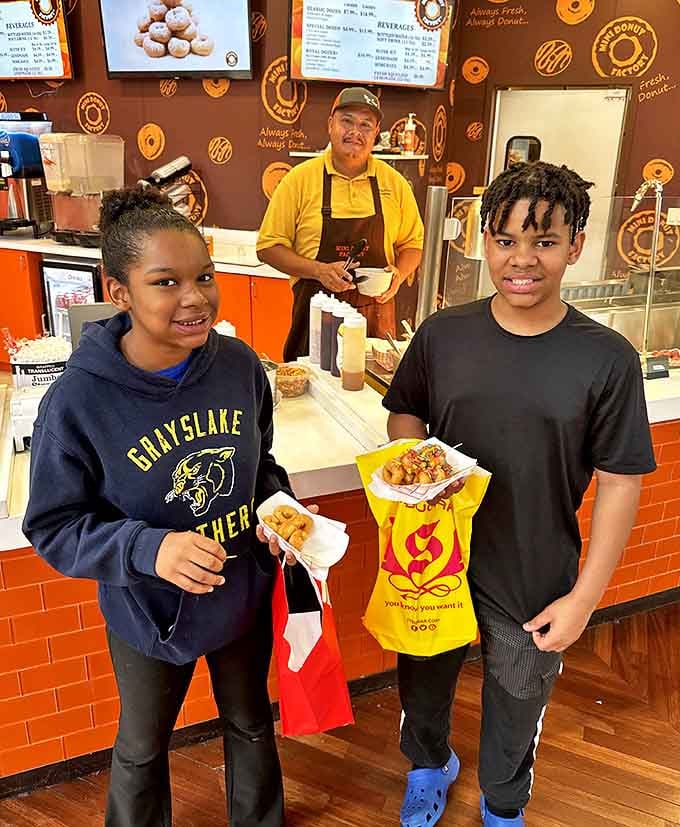 Happy customers clutching bags of treats, with that unmistakable look of people who've made an excellent life decision.