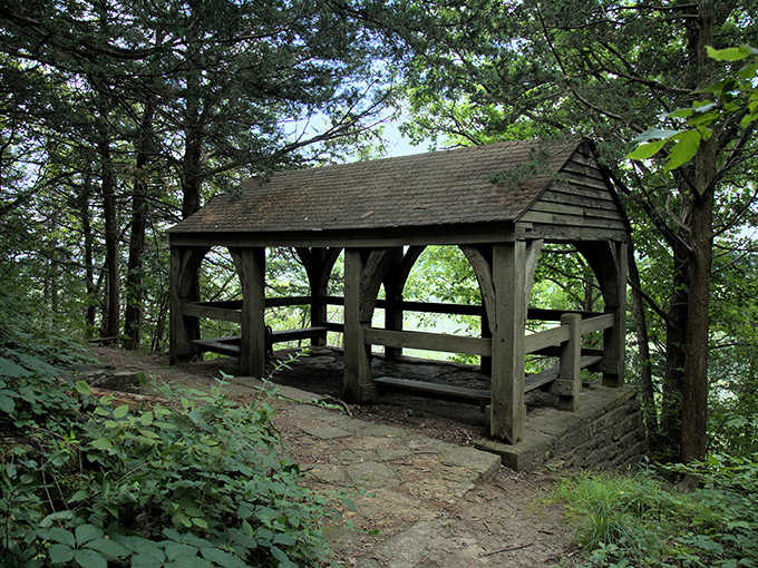 This rustic shelter has weathered countless storms, offering weary hikers a moment of respite and protection from summer showers.