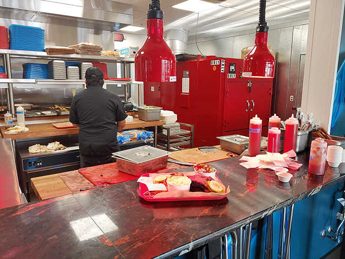 Behind the scenes, culinary wizards orchestrate smoky symphonies in a kitchen where BBQ is treated with religious reverence.