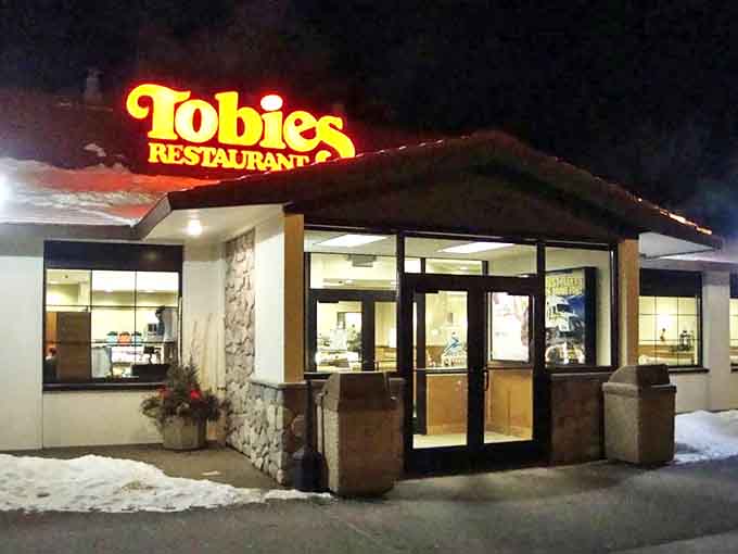 Even after dark, Tobie's warm glow serves as a beacon for hungry travelers, promising comfort food and Minnesota hospitality regardless of the hour.