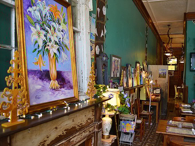 Local artwork lines the walls, transforming a simple hallway into an impromptu gallery where diners can feast their eyes between courses.