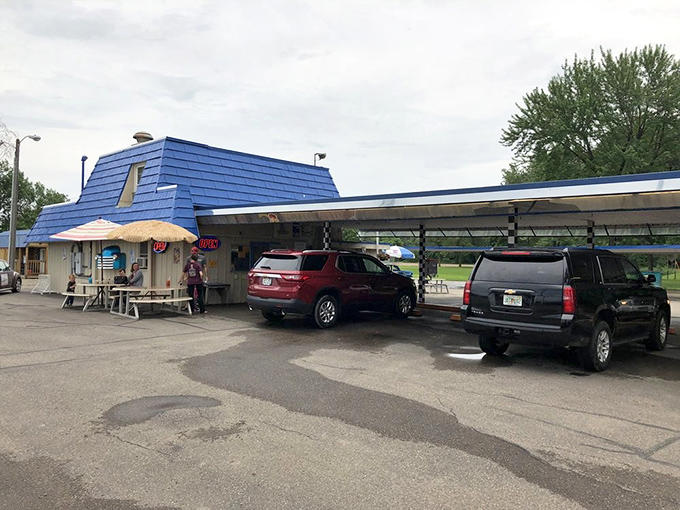 The Little Brown Jug welcomes guests with rustic charm, shady trees, and easy parking out front.