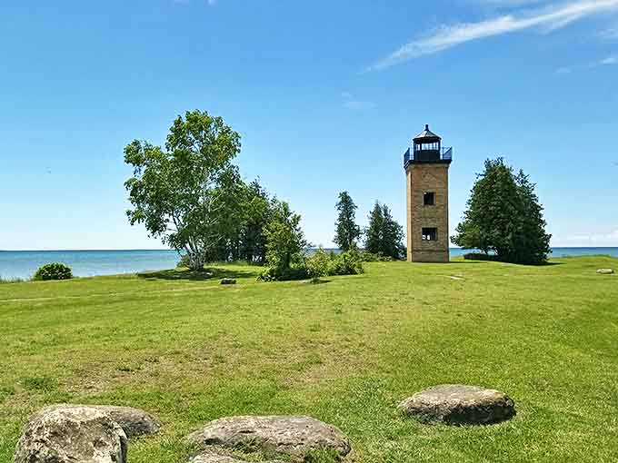 Peninsula Point Lighthouse stands guard over Lake Michigan's waters, a stone sentinel with stories etched into every brick.