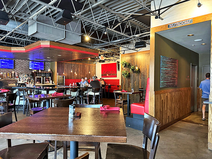 Another angle reveals more of the restaurant's thoughtful design &ndash; exposed ductwork above warm wood and those signature red accents.