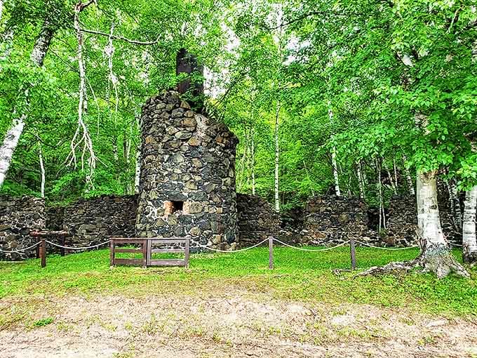 This stone chimney once vented steam from pumps that kept the mine dry, standing sentinel over a forgotten industrial landscape.