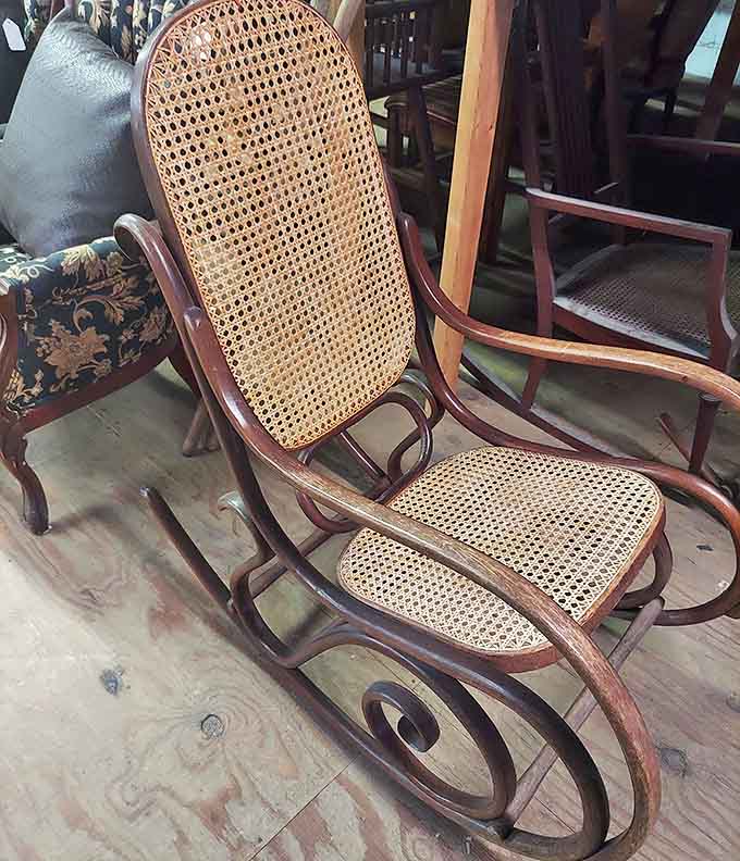 This caned rocking chair has been soothing souls for generations, its curved arms ready to embrace another century of gentle motion.