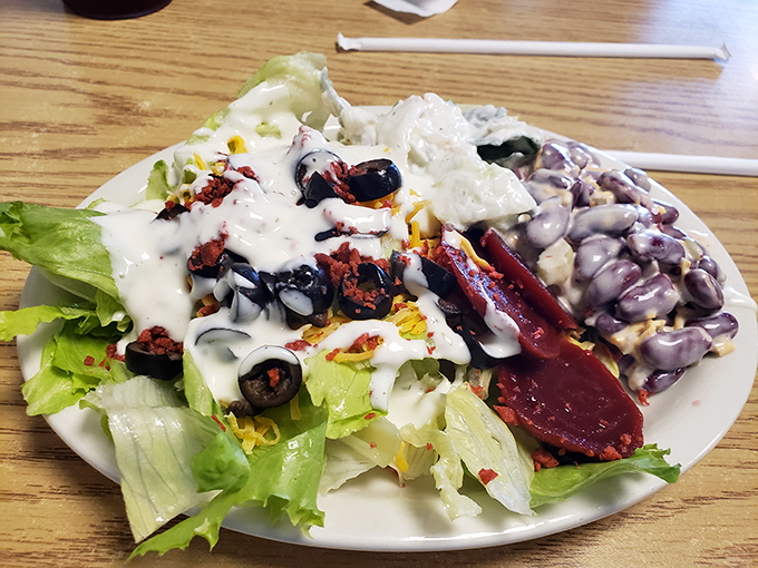 Even the salad refuses to be boring &ndash; crisp lettuce, olives, and enough toppings to make you forget you ordered something healthy.