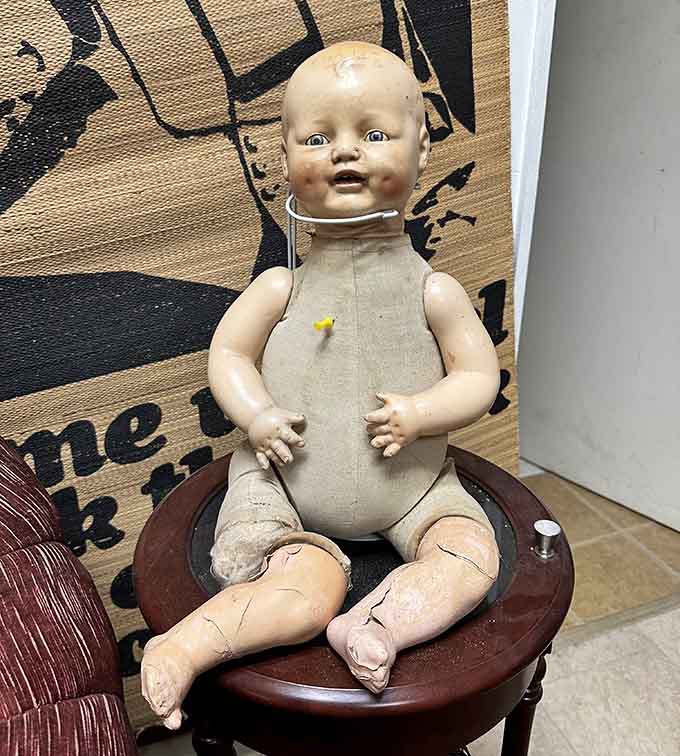 This weathered antique doll has survived decades with remarkable grace, though its slightly cracked complexion adds character that new dolls simply can't match.