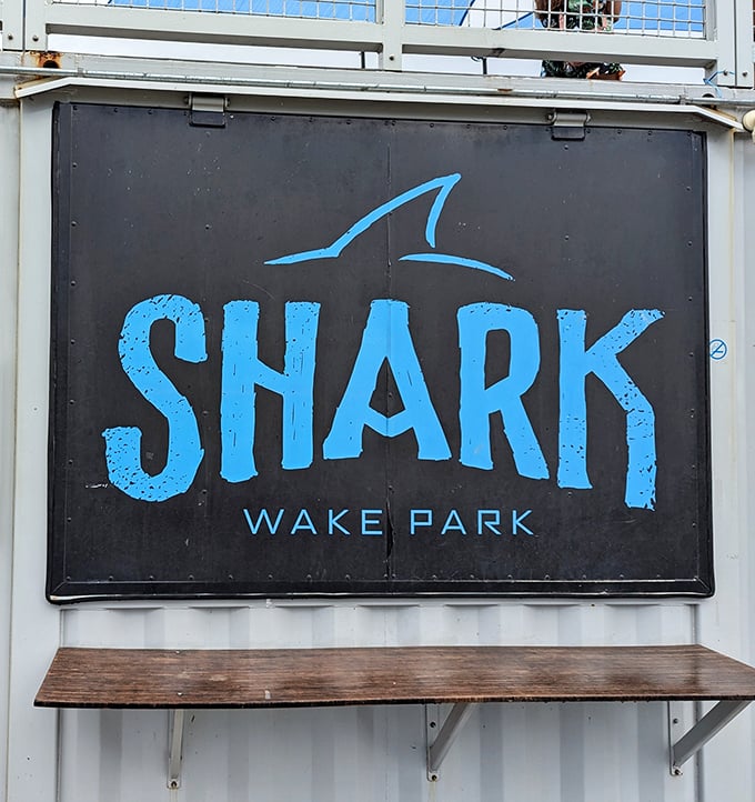 The iconic Shark Wake Park sign stands as a beacon for thrill-seekers, promising aquatic adventures beyond the ordinary splash-and-swim experience.