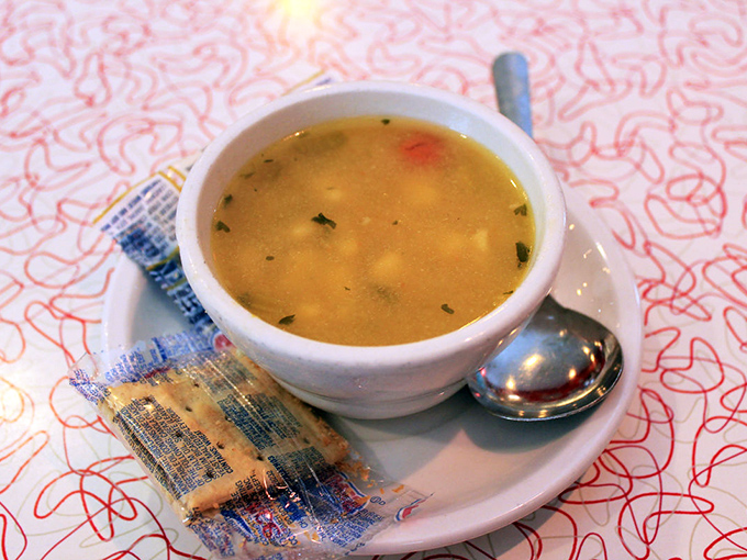 Homemade soup that warms both body and soul &ndash; served with crackers and a side of nostalgia in classic diner dishware.