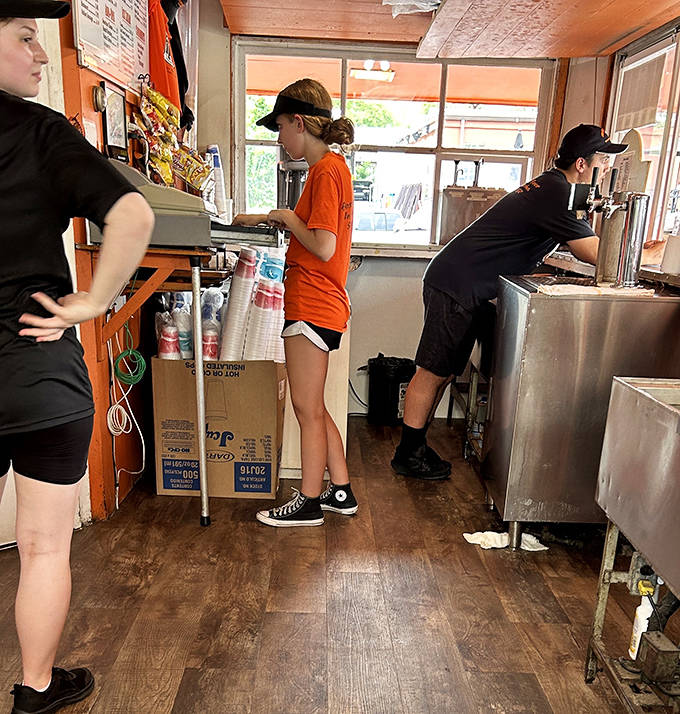 Behind the counter, the choreographed efficiency of a team that's been perfecting the art of root beer service for generations.