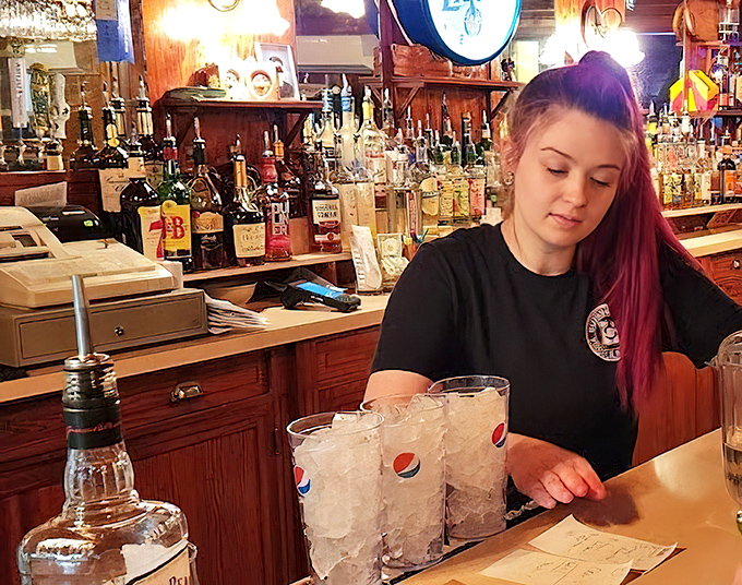 Behind the bar, skilled hands prepare drinks with the confidence that comes from years of experience.