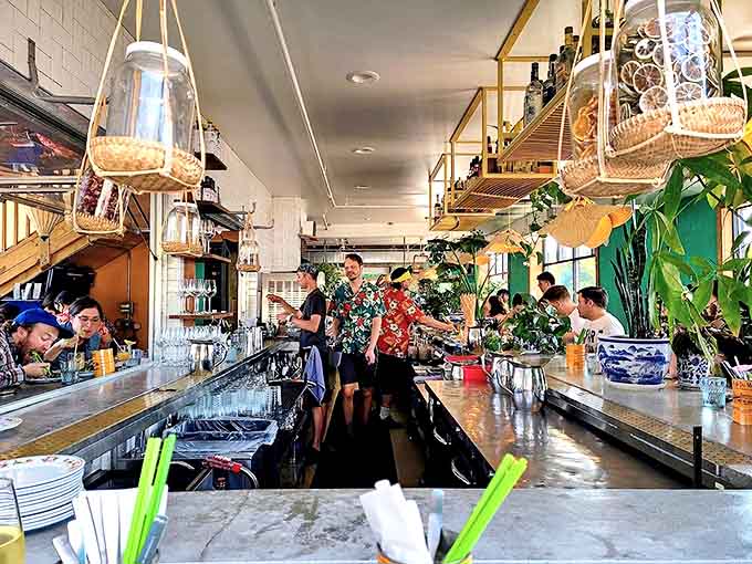 The bustling bar area features staff in tropical shirts serving up colorful concoctions to eager patrons in this Southeast Asian oasis.