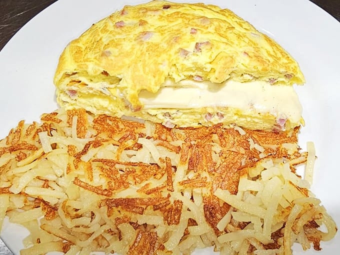 A perfectly executed ham omelet with hash browns demonstrates that sometimes the classics don't need improvement, just proper technique and fresh ingredients that actually taste like something.