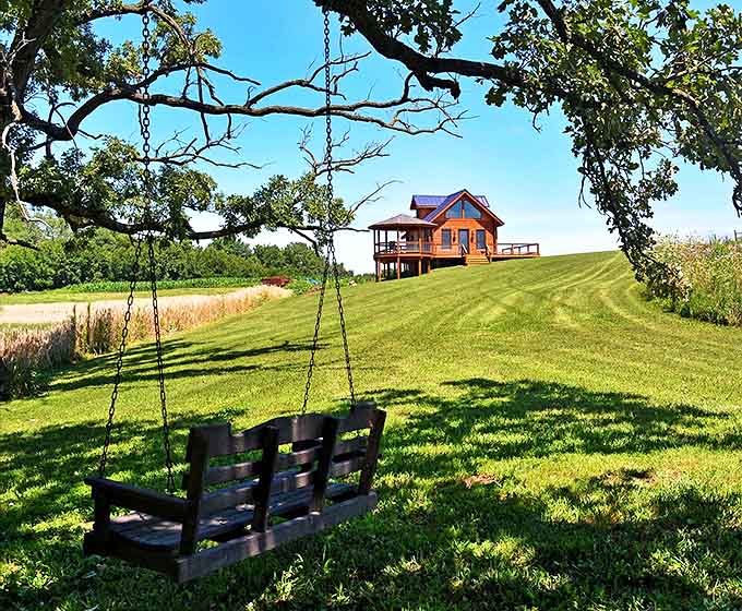 This simple tree swing invites childlike joy, offering gentle sways with views that stretch for miles &ndash; childhood summers distilled into one perfect spot.
