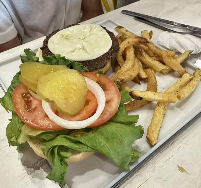 The Native Burger arrives with perfectly golden fries &ndash; a testament that even the classics get special treatment at this beachside haven.