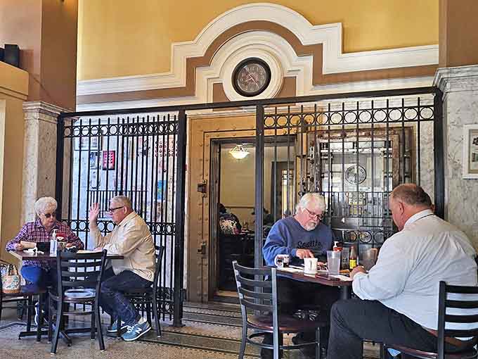 Locals gather around historic tables where transactions once happened, now exchanging stories and laughter over plates of comfort food classics.
