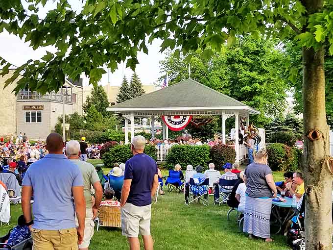 The Village Green transforms into a community living room during summer concerts, where lawn chairs replace sofas and music replaces television.