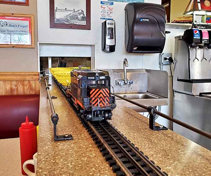 The main attraction in miniature form – a model train makes its journey along the counter, delivering burgers where no server has gone before.