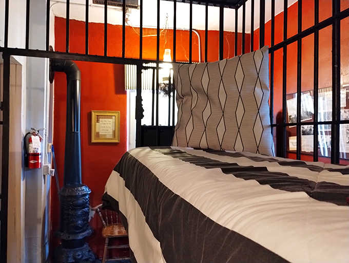 Bold red walls and authentic cell bars create a dramatic backdrop for this uniquely themed accommodation that's anything but ordinary.