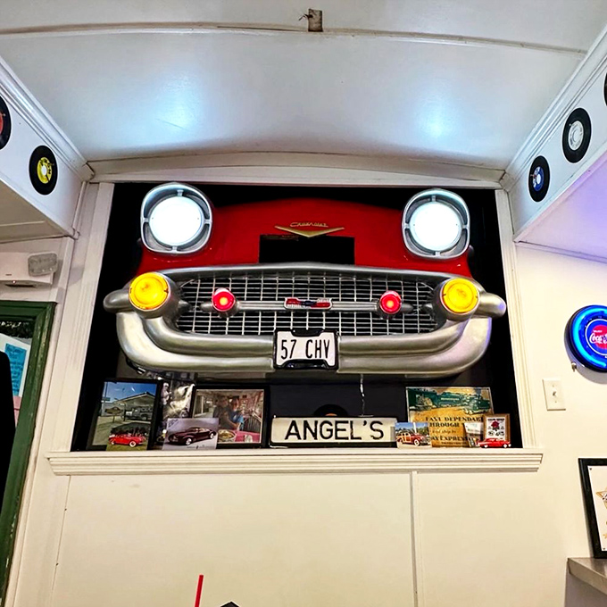 The view down the aisle where countless meals have traveled from kitchen to customer, past vinyl records and neon lights that have witnessed decades of satisfied appetites.