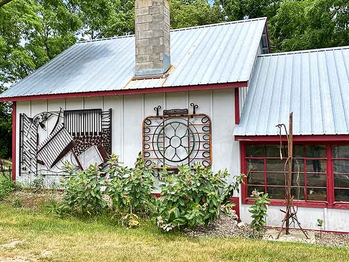 A white workshop building that serves as home base for all this creative chaos, where imagination gets its hands dirty.