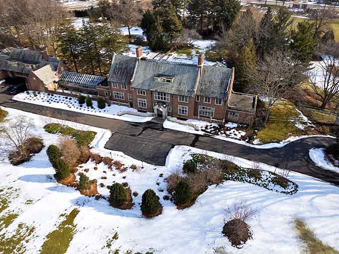 This aerial winter view reveals Applewood's impressive footprint, with the main house commanding attention even when blanketed in Michigan snow.