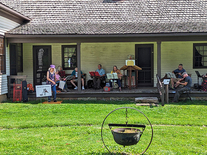 Musicians on the porch fill the air with period melodies, their instruments and traditional tunes creating an authentic soundscape.